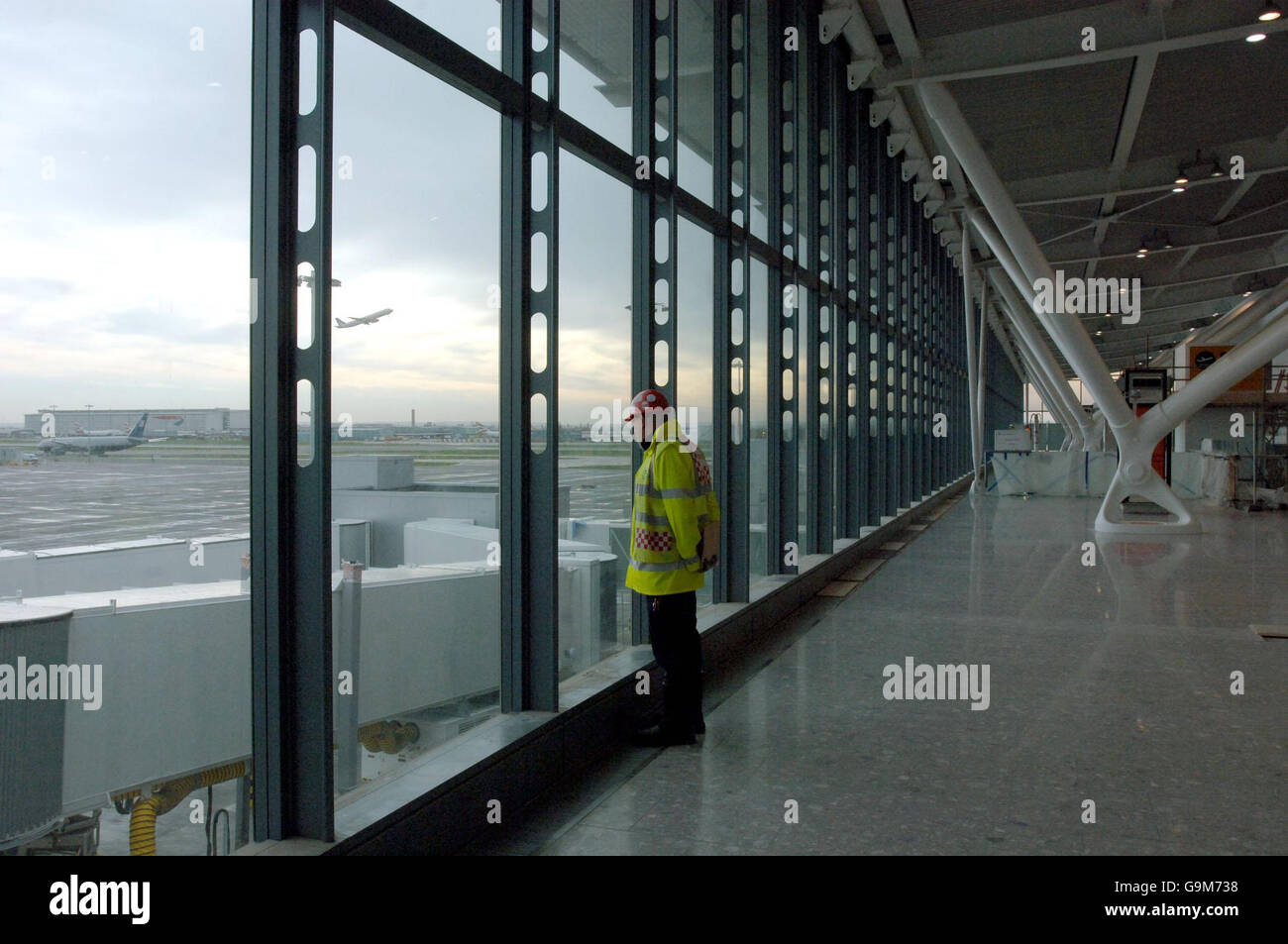 A worker looks out of the panoramic window of one of the two satellites ...