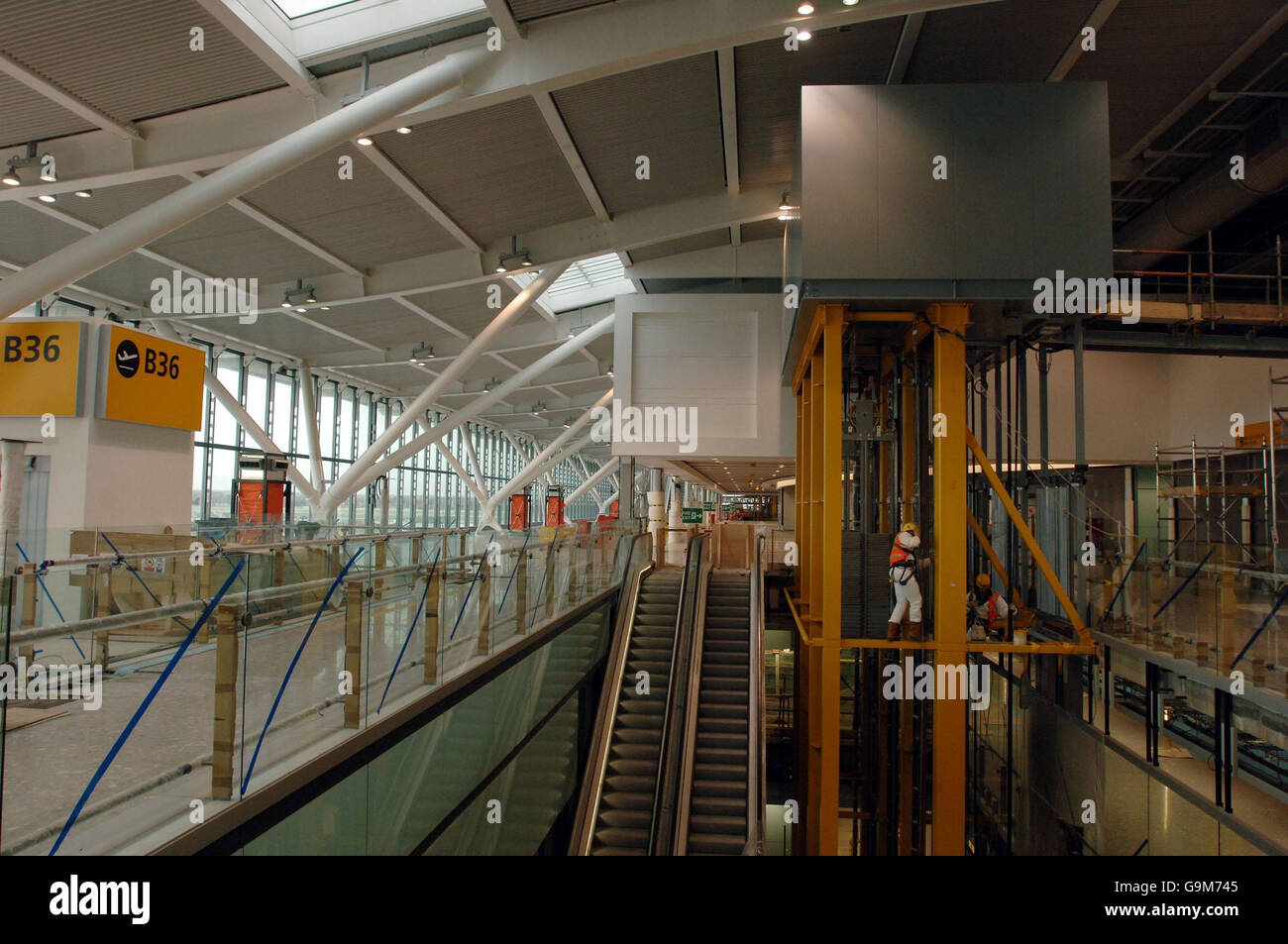 Workers in the new Terminal Five at Heathrow Airport, which will open ...