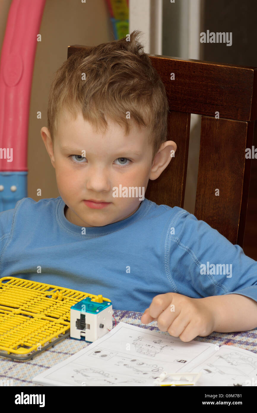 Child blond boy sitting table hi-res stock photography and images - Alamy