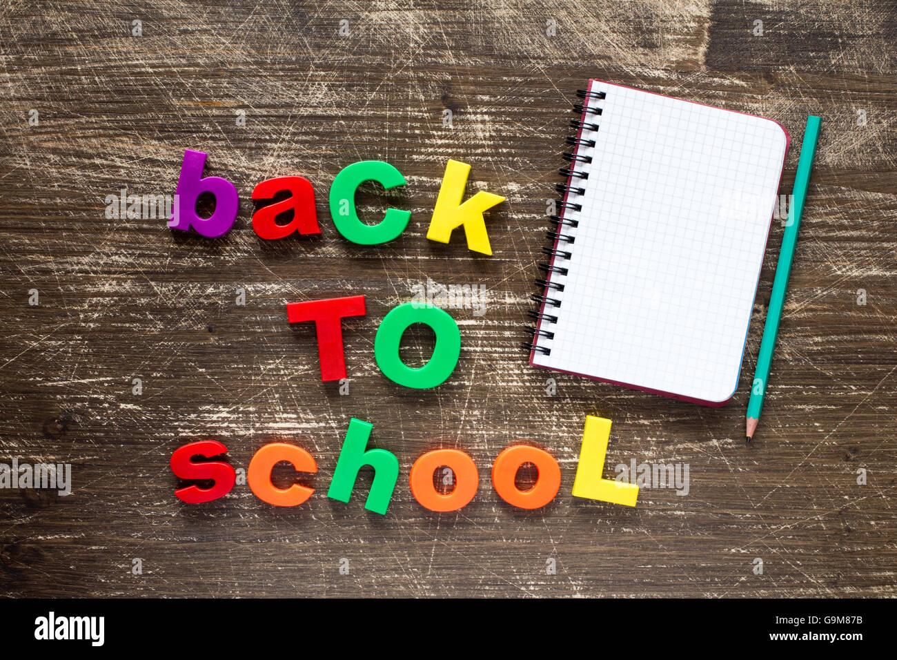 Sentence Back to school in colorful plastic letters and blank notebook ...