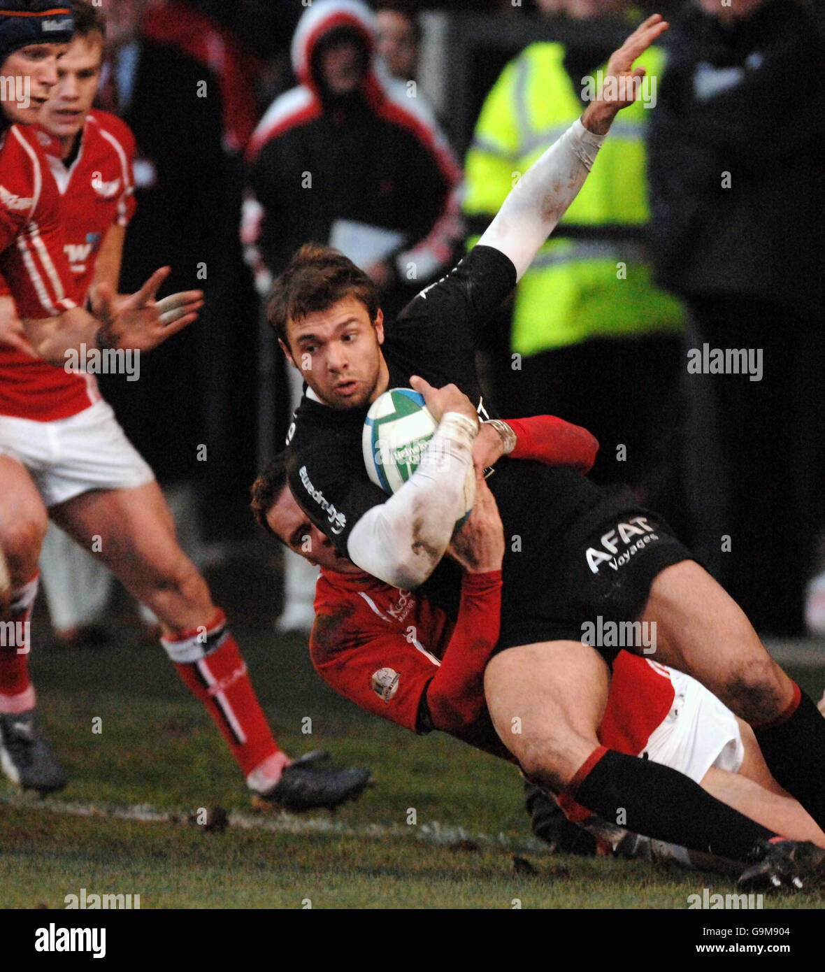 Llanelli Scarlets' Mark Jones catches Toulouse's Vincent Clerc (right ...