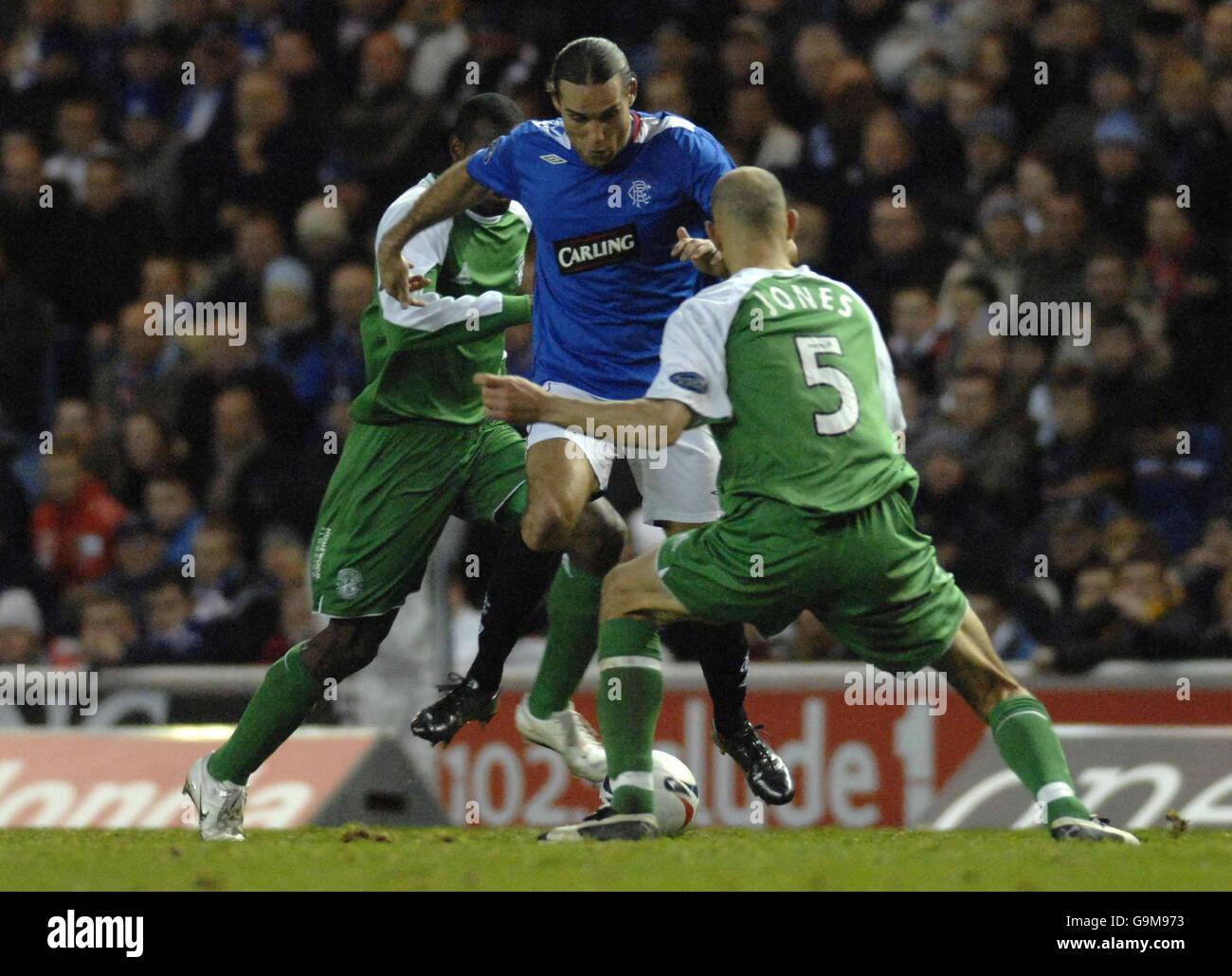 Rangers Dado Prso runs into the tackle from Hibernian's Rob Jones ...