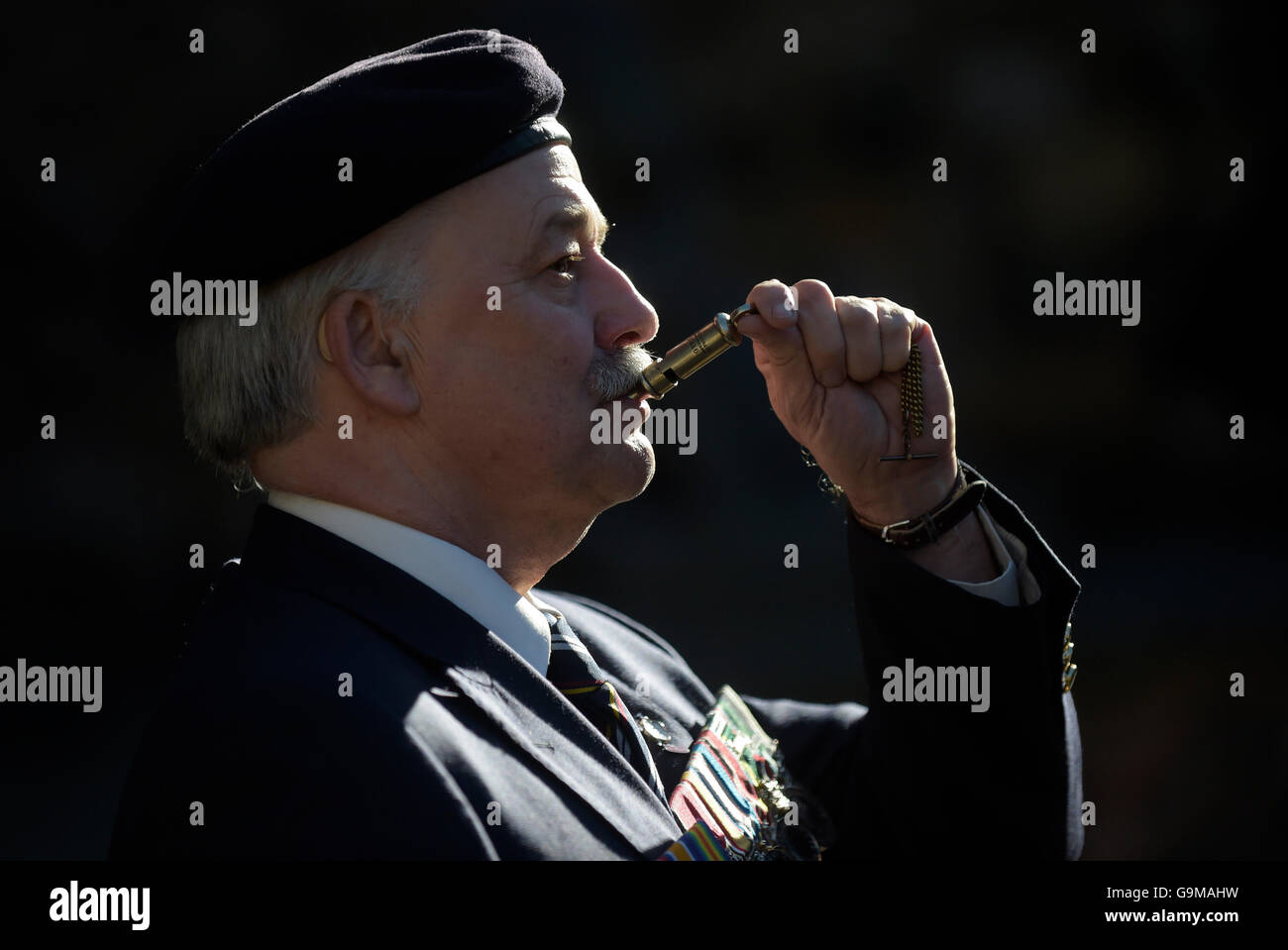 Alan Hamilton blows a whistle to signal the end of the two minute ...