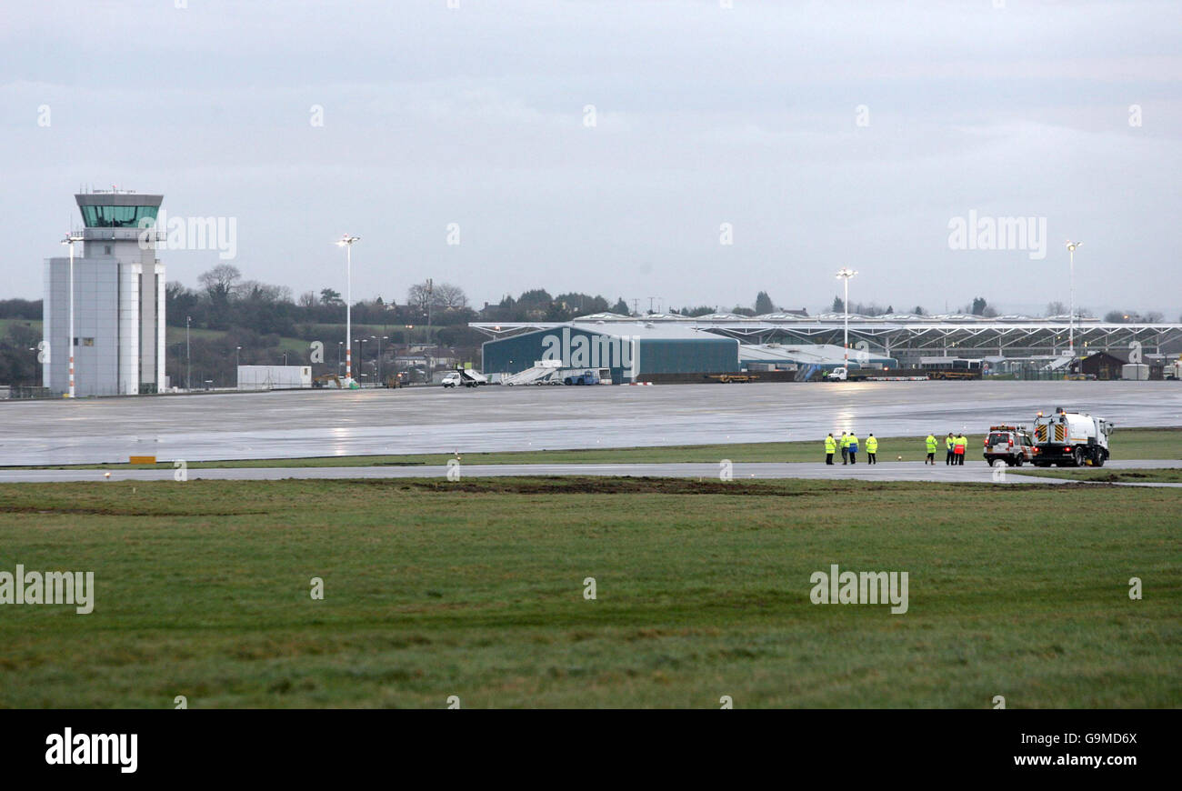 Staff inspect the runway at Bristol International Airport this morning ...
