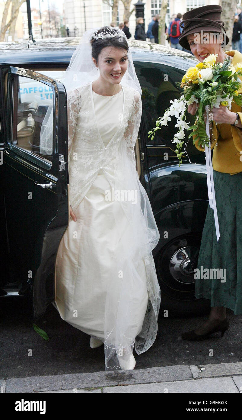 Full length arriving eye contact smiling wedding dress flowers bouquet ...