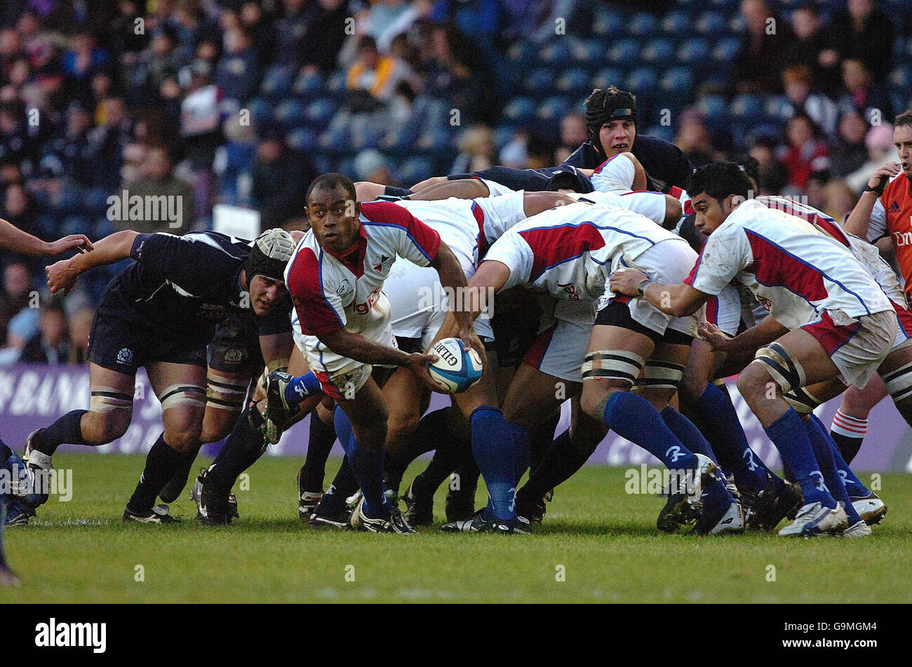 Pacific Islands scrum half Moses Rauluni with ball as Scotland Kelly ...