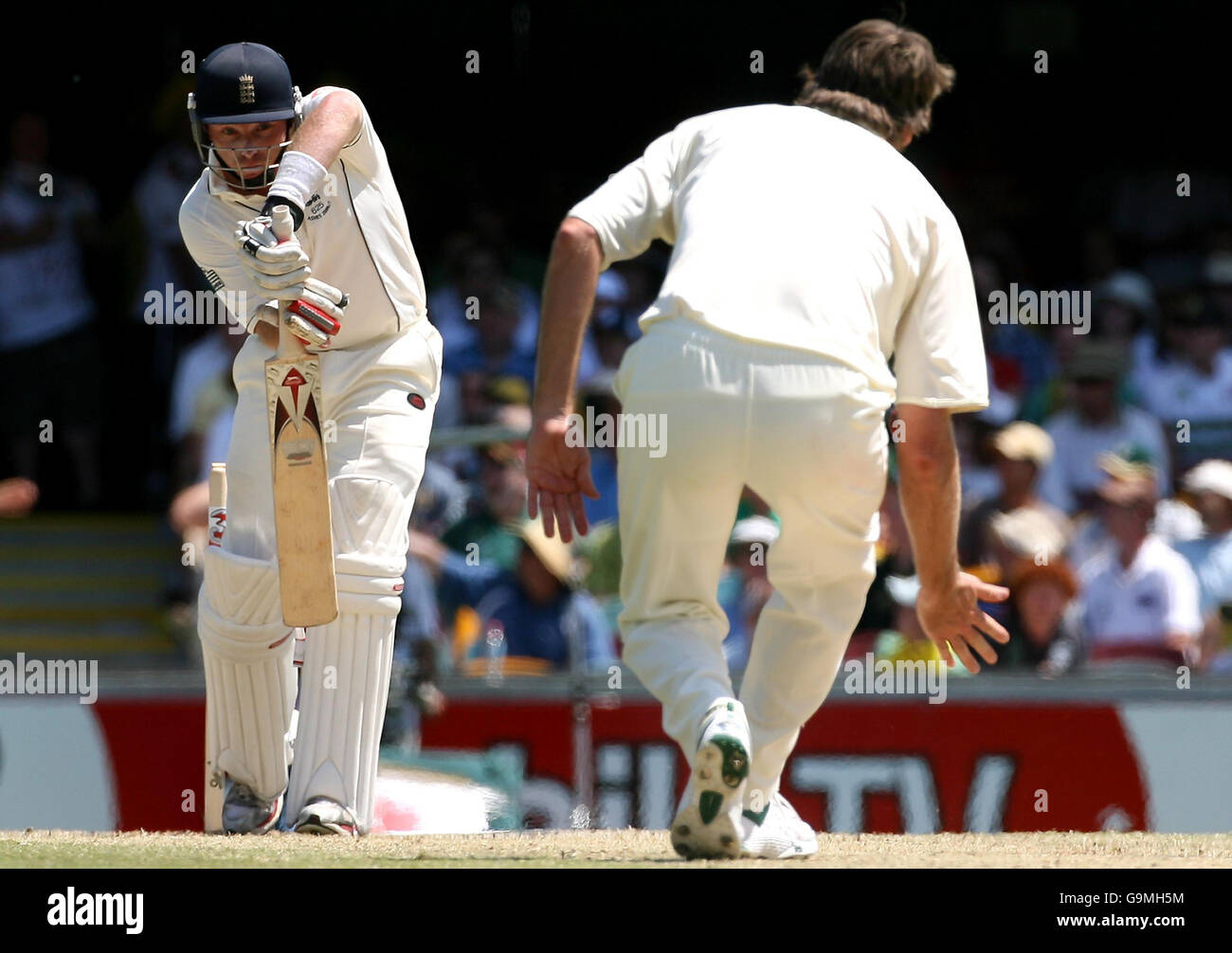 England's Ian Bell block plays a shot against Australia's Glenn McGrath ...