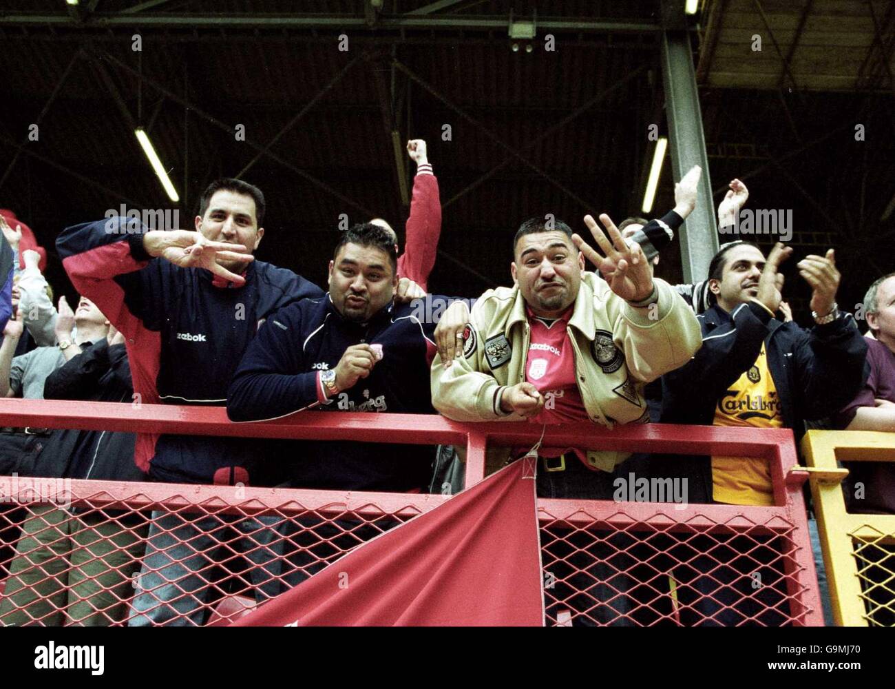 Liverpool fans celebrate at the end of the game by hand signalling a ...