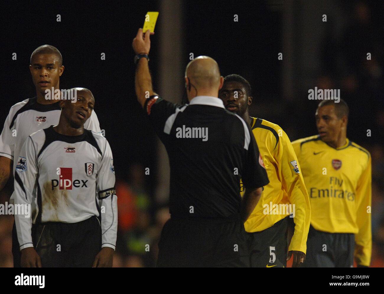 Referee Howard Webb brandishes yet another yellow card, this time for ...