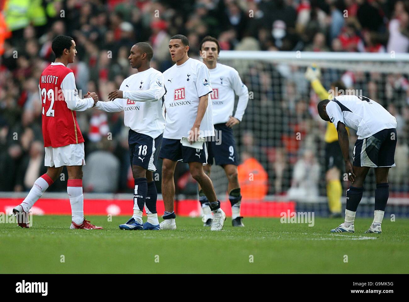 Arsenal's Theo Walcott shakes hands with the Tottenham Hotspur players ...