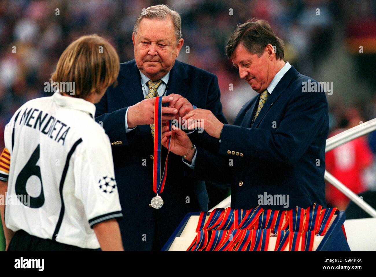 UEFA Chief Executive Gerhard Aigner (r) passes a runners up medal to ...