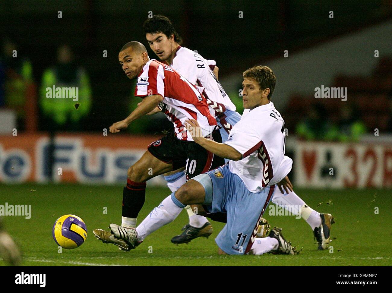 Sheffield United's Danny Webber (center) comes under pressure from ...