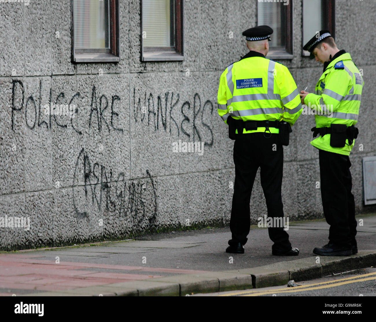 Police officers record the details of Graffiti near Brighton ...