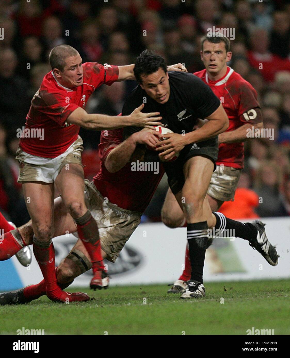 New Zealand's Rico Gear (c) heads for the line and tries to avoid the ...