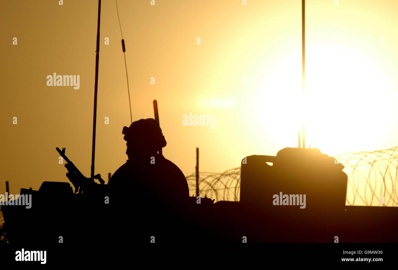 A Royal Marine Commando sits in the gun turret of a Viking personnel ...