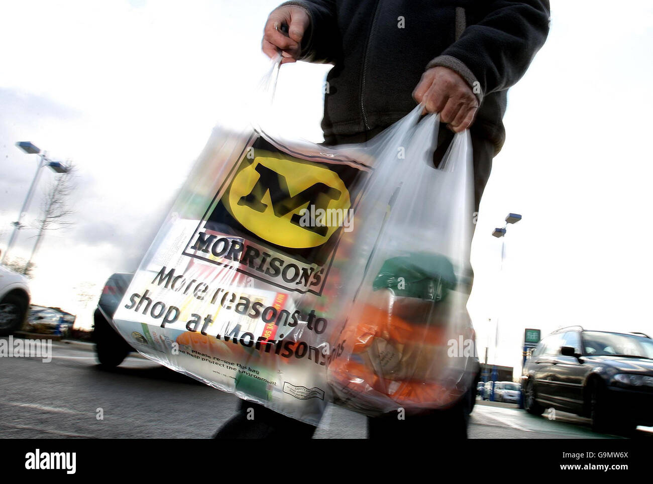 A member of the public with a Morrisons shopping bag outside a ...