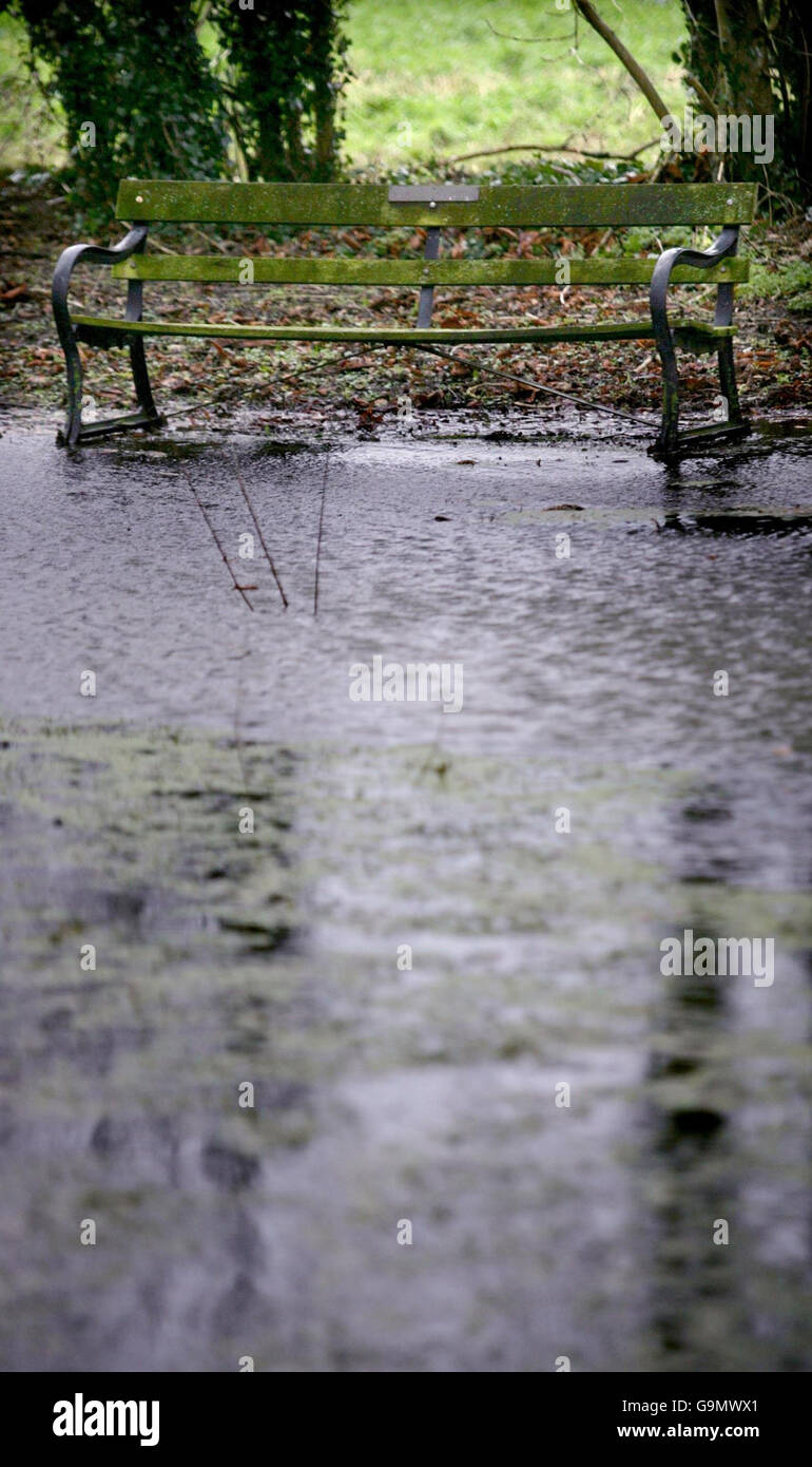 A bench seen in flooded garden in didmarton hi-res stock photography ...