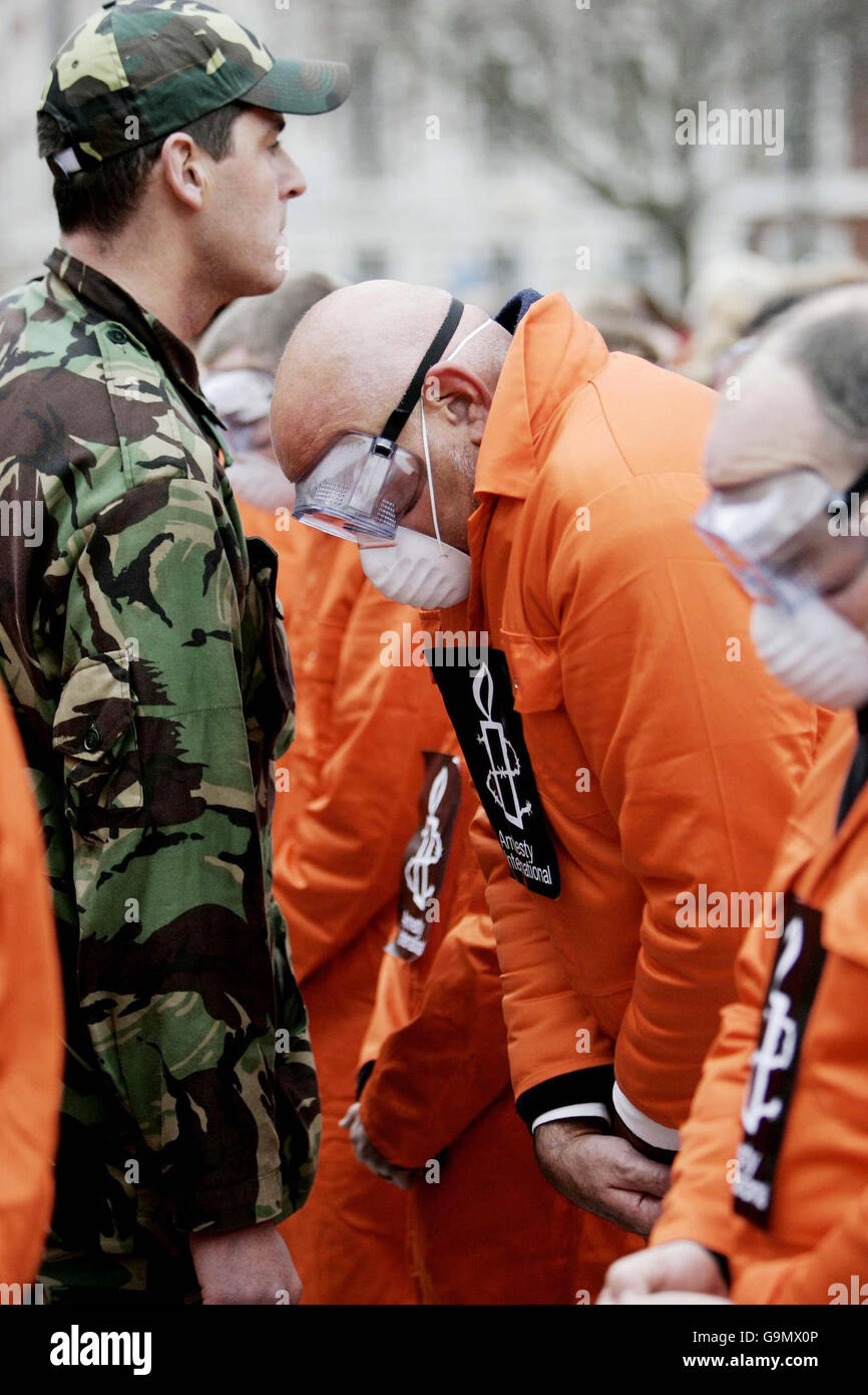 Amnesty International demonstrators in orange boiler suits protest ...