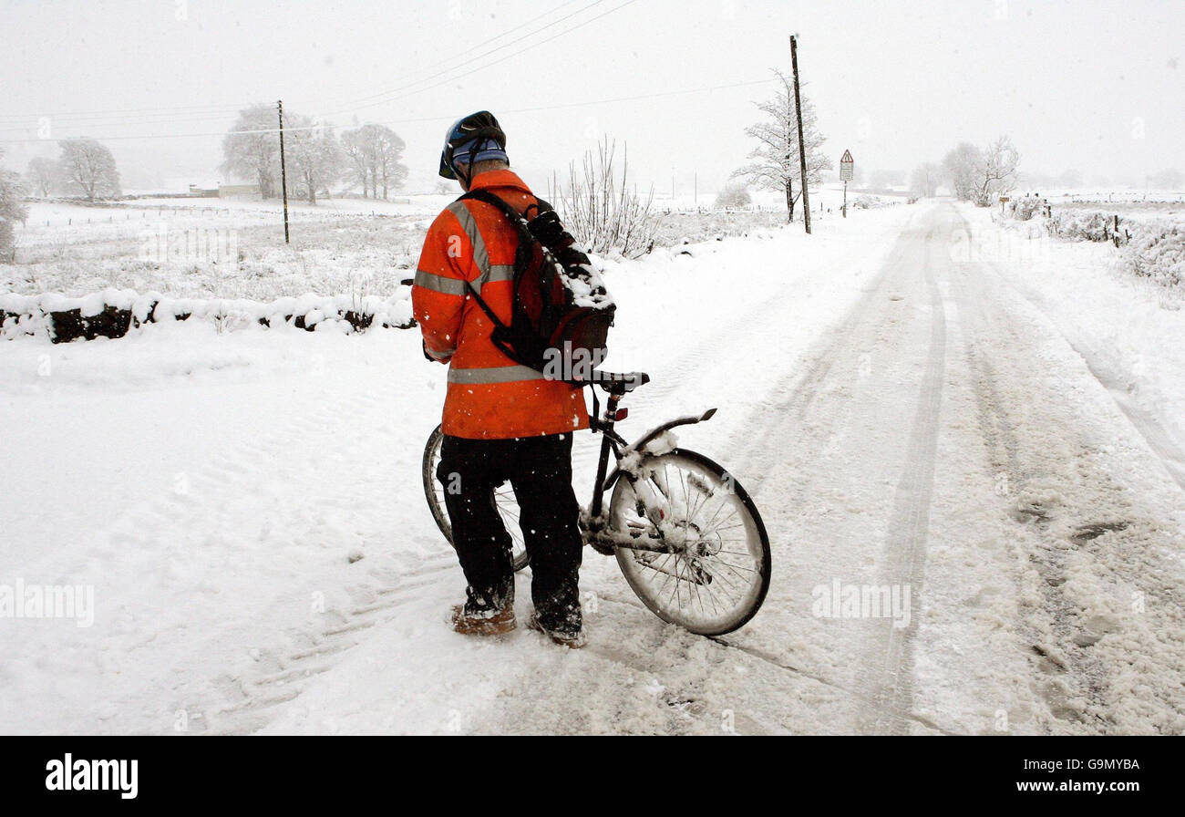 A man pushes a bike at Carronbridge near Denny in Scotland after heavy ...