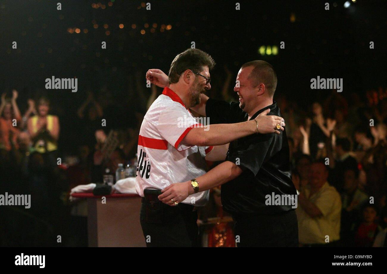 England's Martin Adams left, hugs Mervyn King after beating him during ...