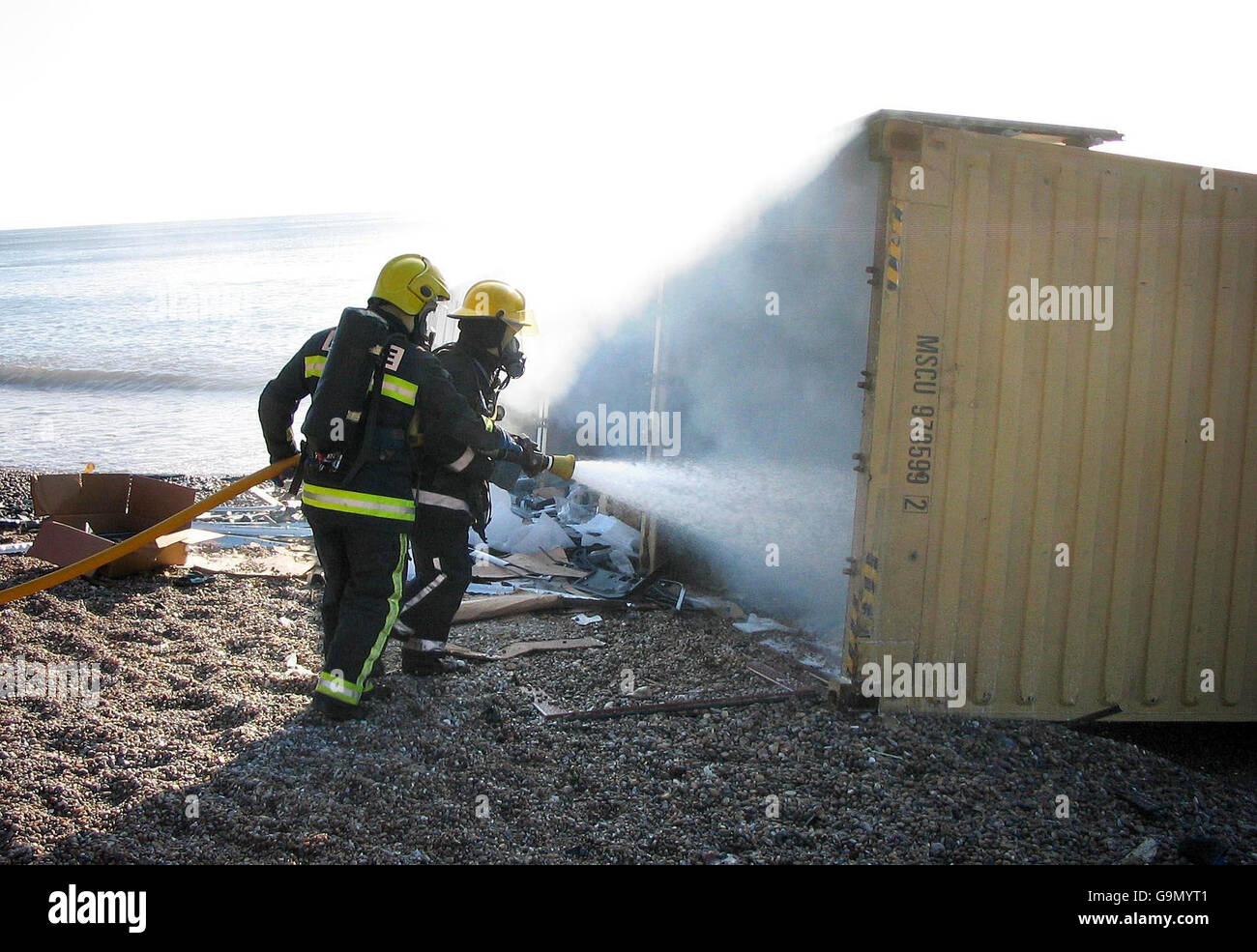 Firemen douse flames in container hi-res stock photography and images ...