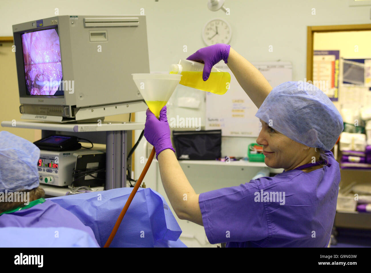 Consultant Surgeon Andrew Miles and Registrar Jim Khan perform a ...