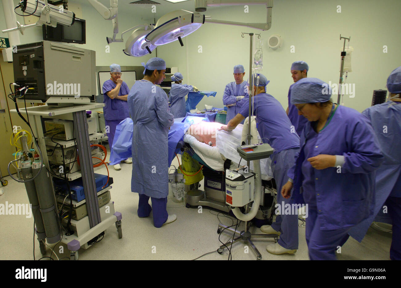 Consultant Surgeon Andrew Miles and Registrar Jim Khan perform a ...