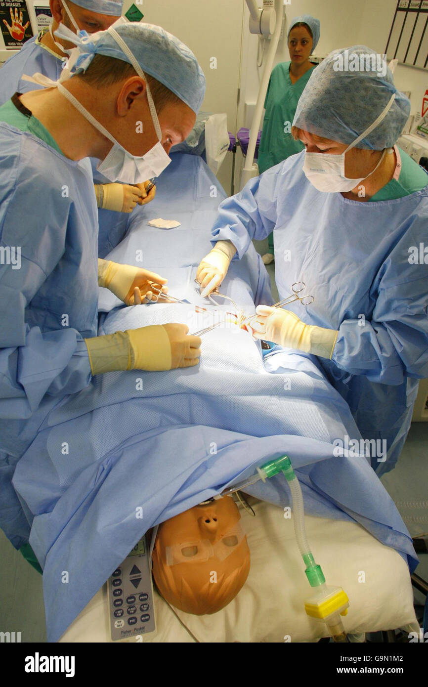 Medical students remove a cyst from the abdomen of a computerised ...