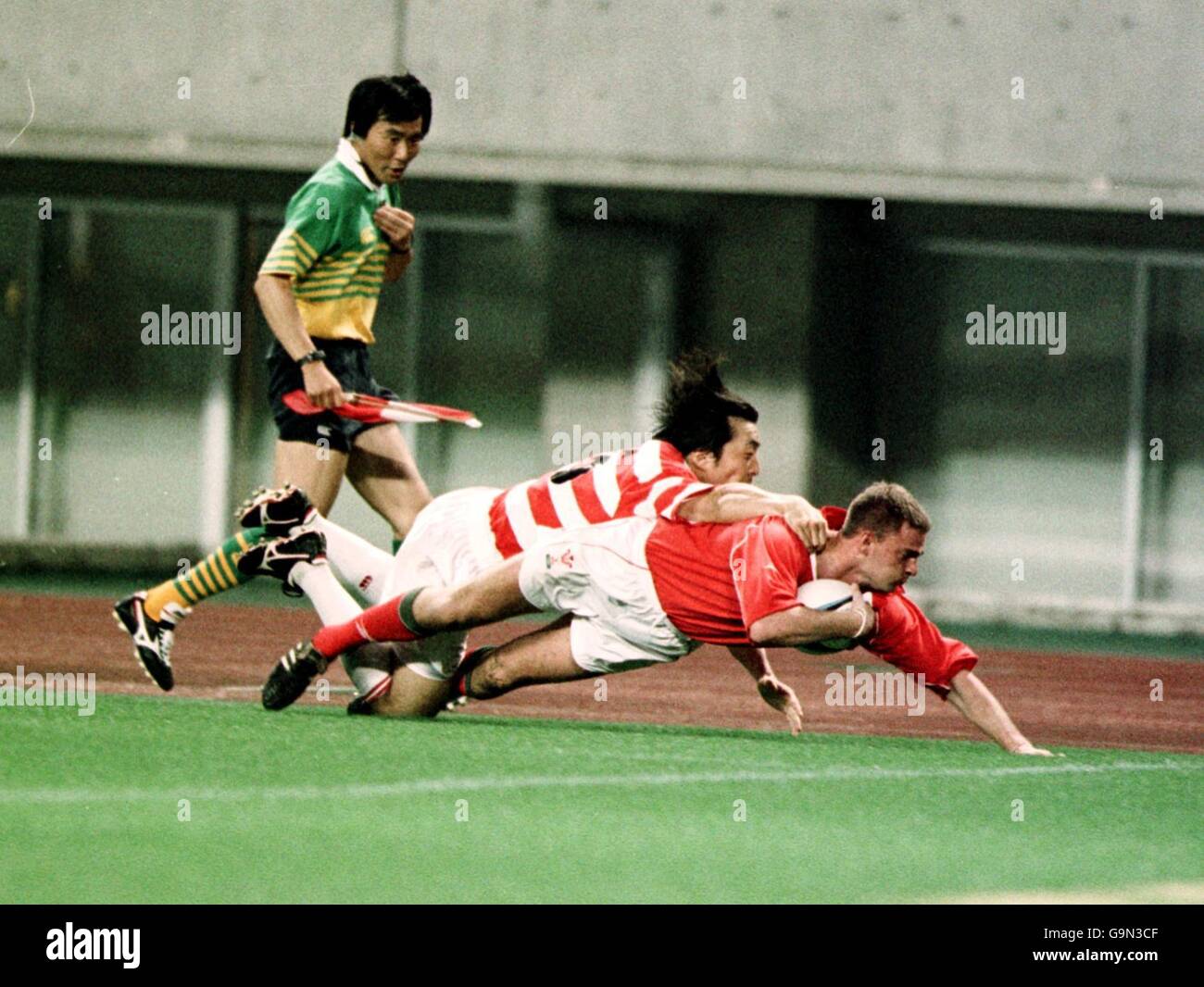 Wales' Adrian Durston dives for the line to score their first try ...