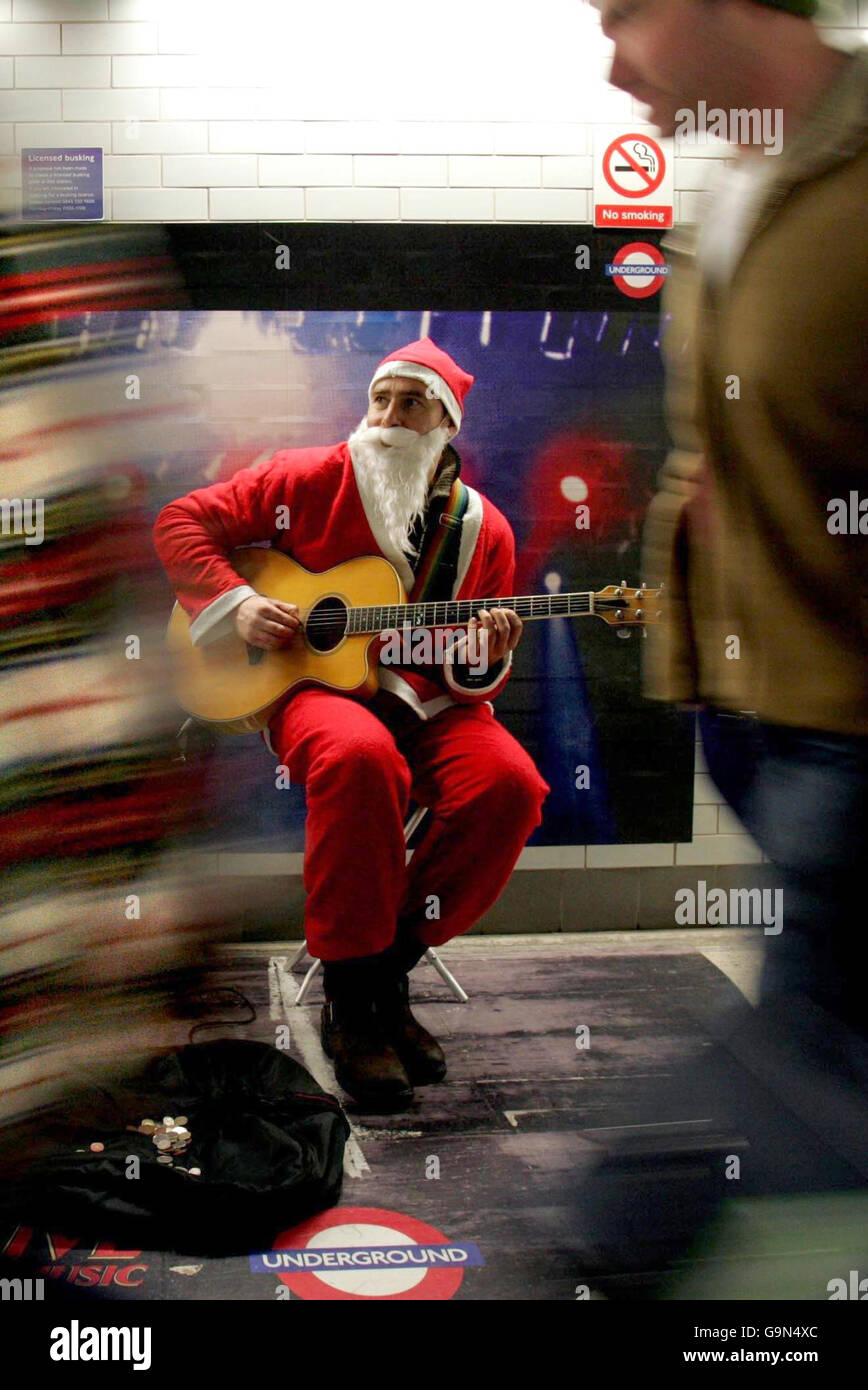 A busker enters into the festive spirit by dressing as Santa Clause and ...