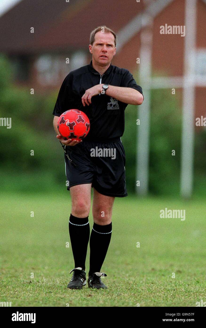 Referee Peter Jones walks off the field at the end of a match with the ...