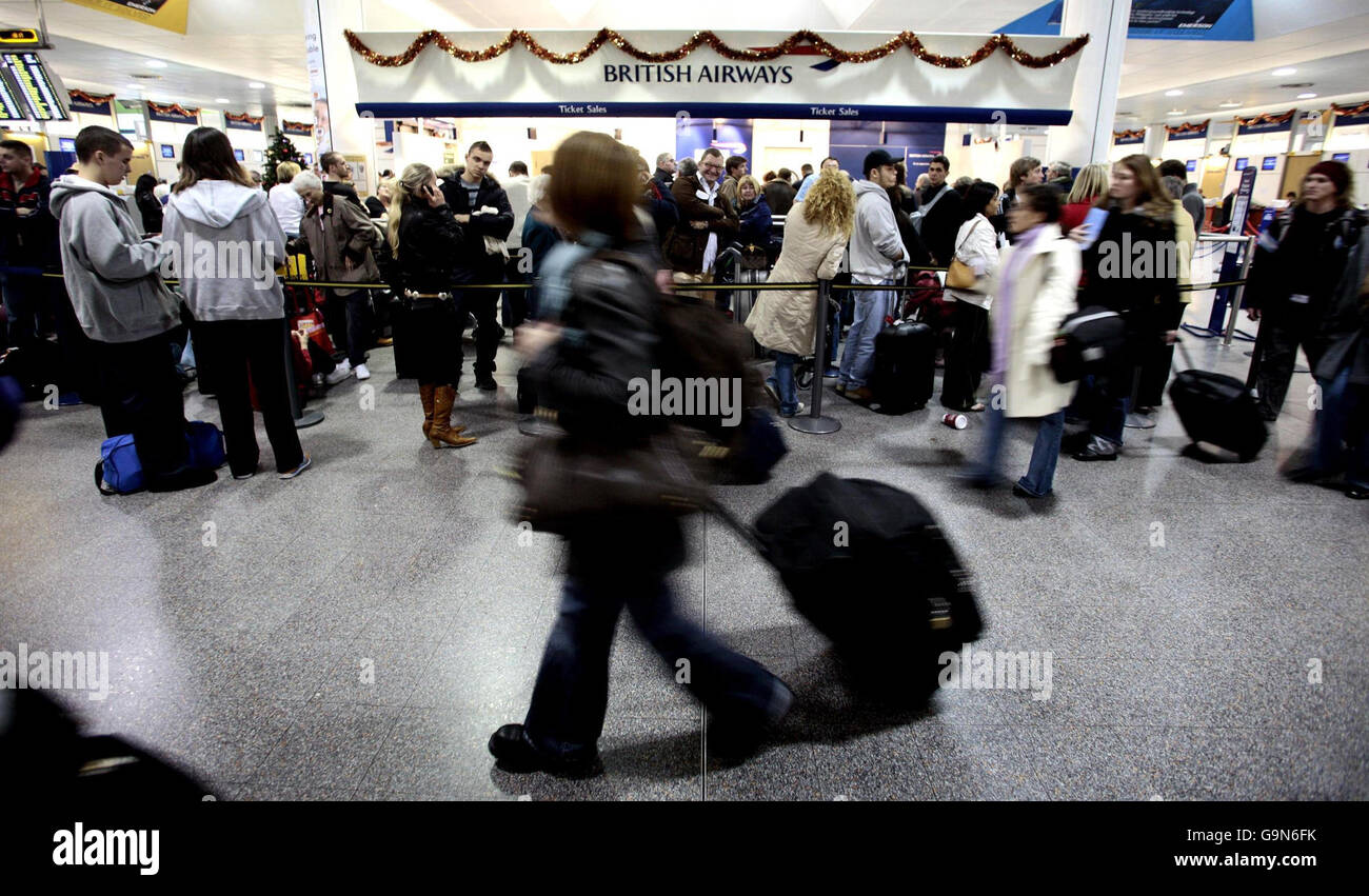 People queue in the North Terminal at Gatwick airport, Sussex, after ...
