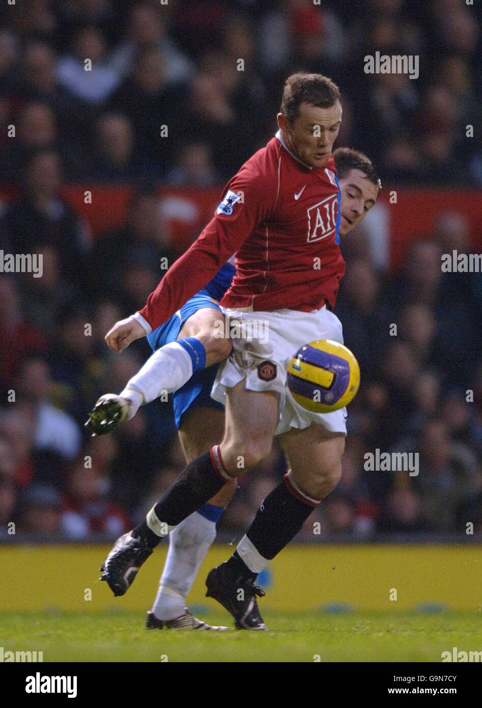 Manchester United's Wayne Rooney and Wigan Athletic's Leighton Baines ...