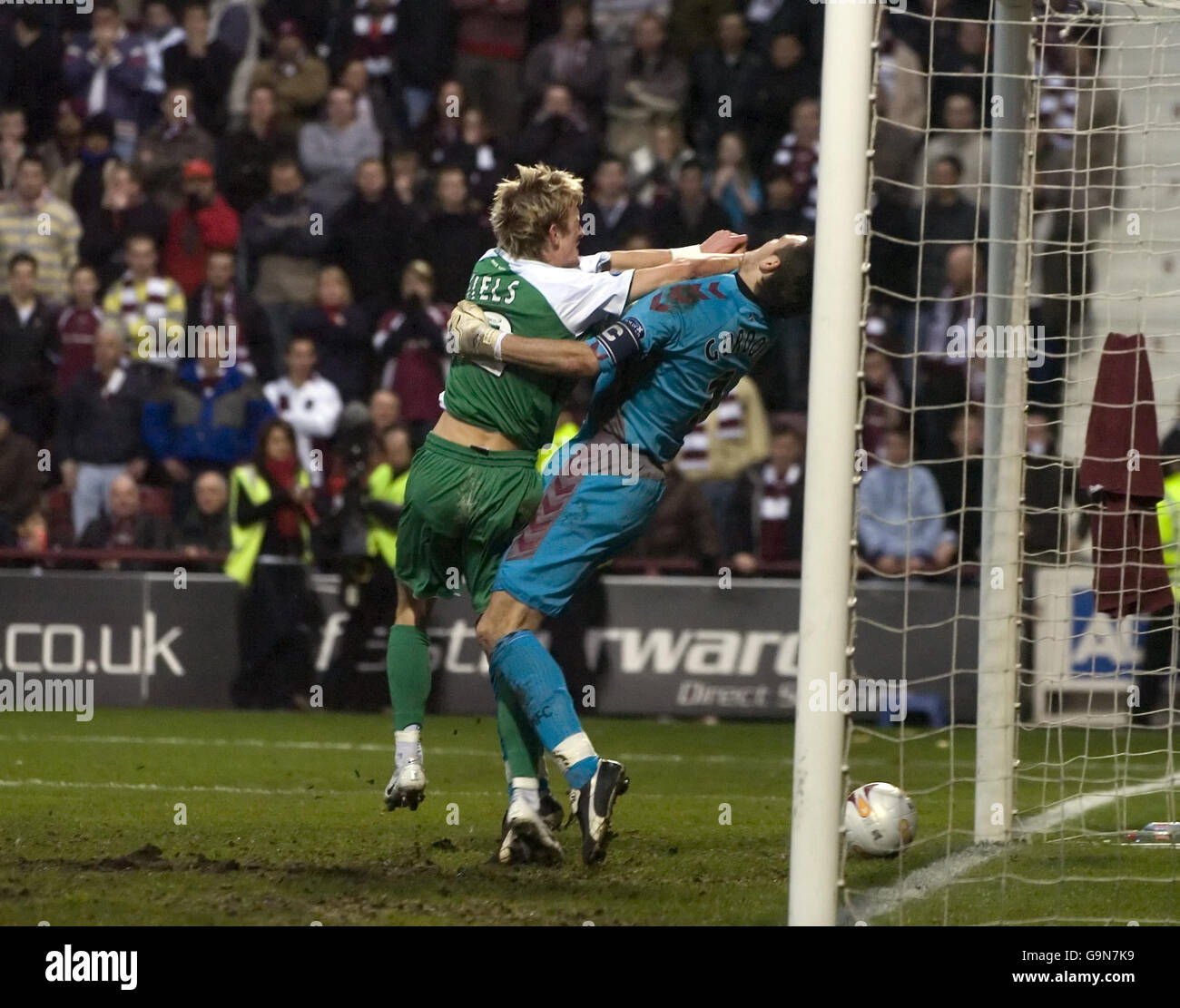 Hibernian's Dean Shiels (left) clashes with Hearts goalkeeper Craig ...