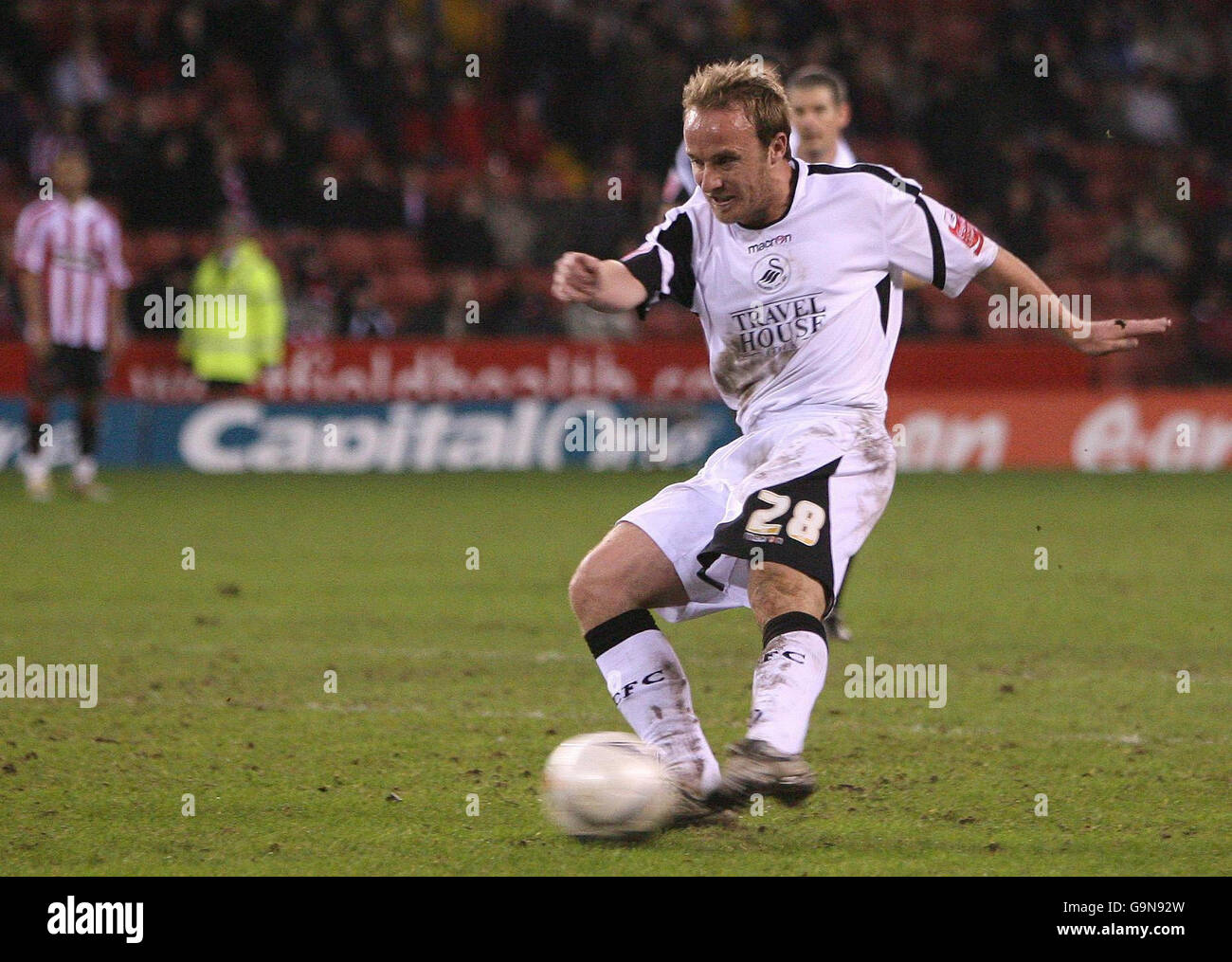 Full length action ball kicking smiling mangsb hi-res stock photography ...