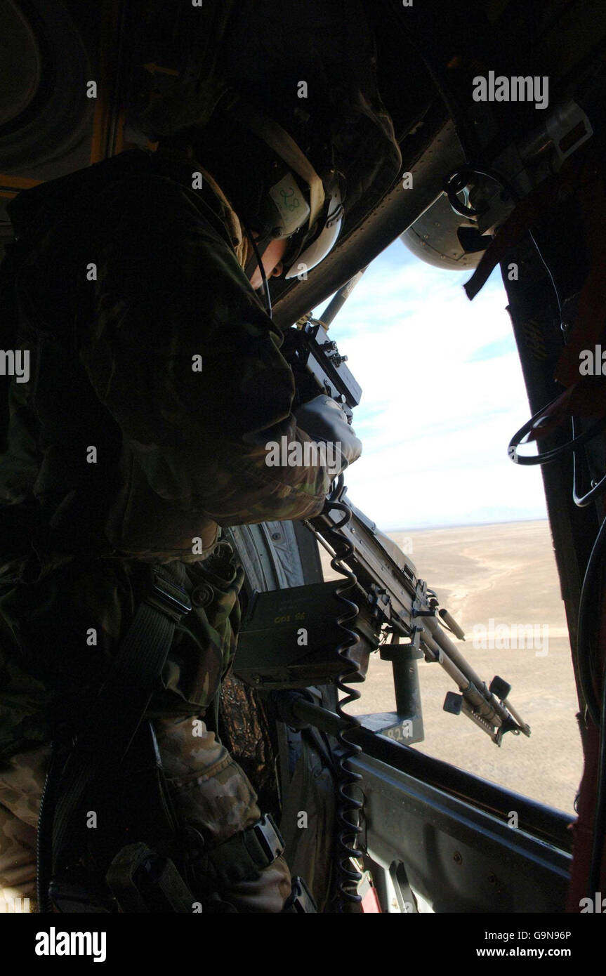 A loadmaster looks out of a RAF Chinook helicopter as flies over ...