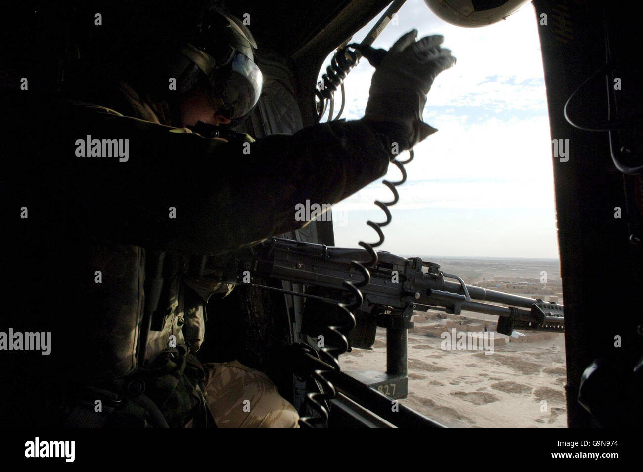 A loadmaster looks out of an RAF Chinook helicopter as it flies over ...
