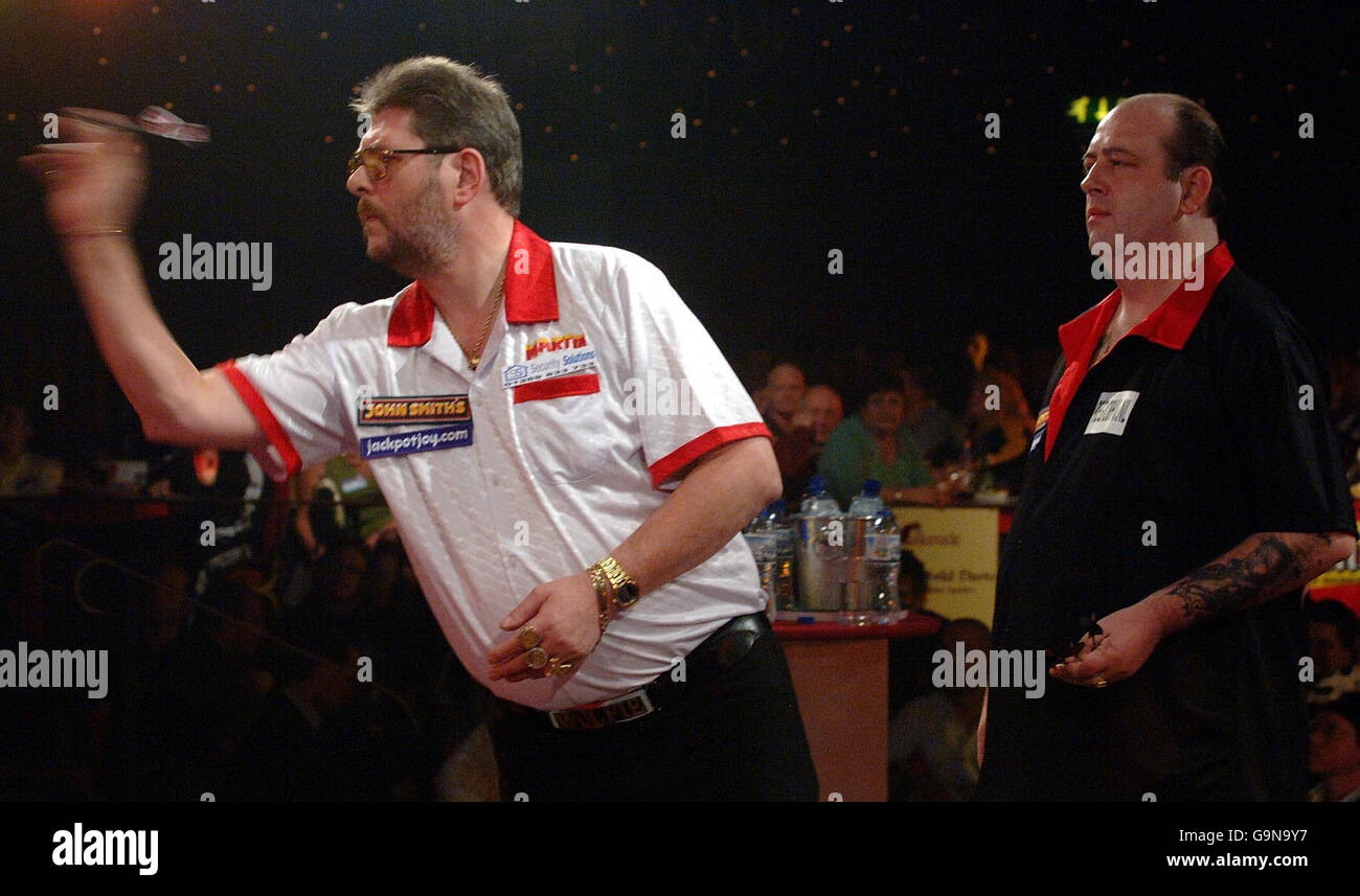 England's Martin Adams throws his darts watched by opponent England's ...