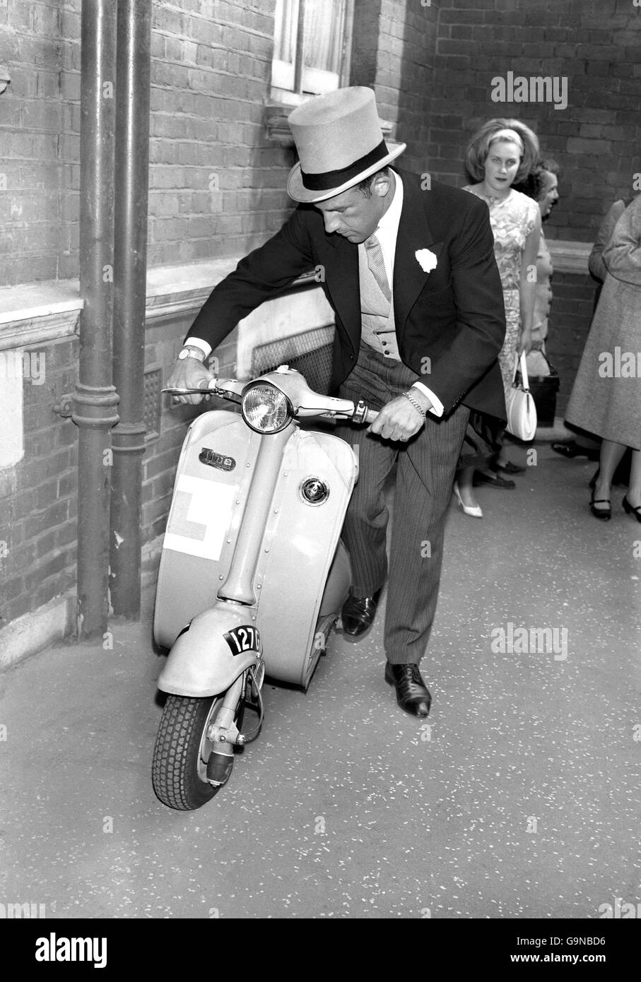 Stirling Moss starts up his Triumph 'Tina' scooter after attending his ...