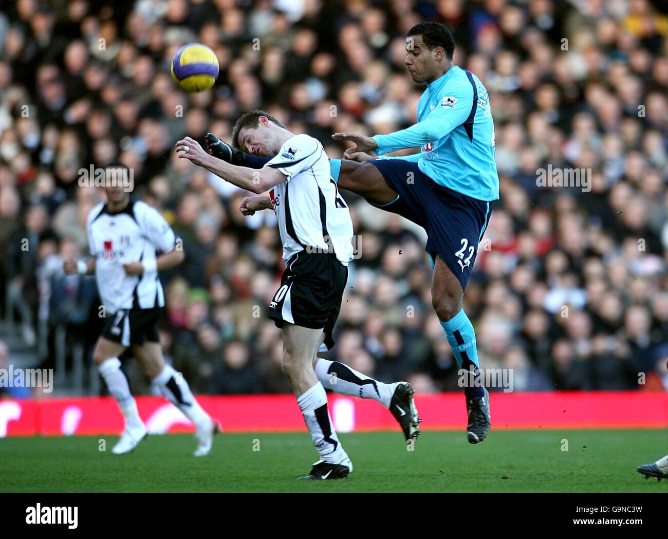 Fulham's Brian McBride (left from center) catches a boot in the face ...