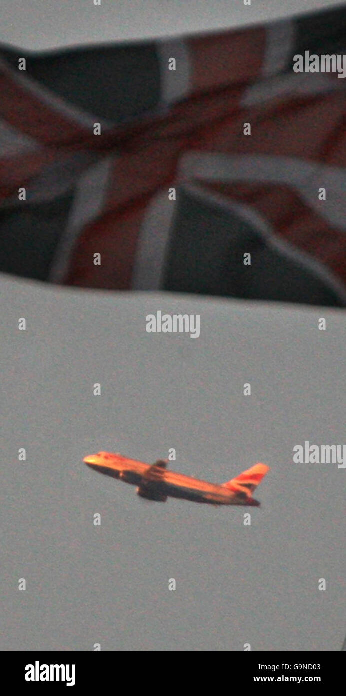 A British Airways plane flies past the Union Jack above Parliament in ...