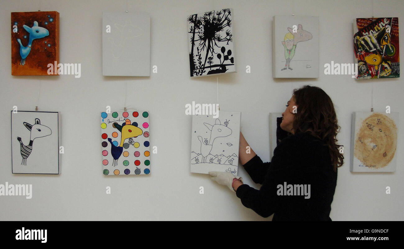 Artist Emma Harding adjusts a picture by musician Moby, which was based ...