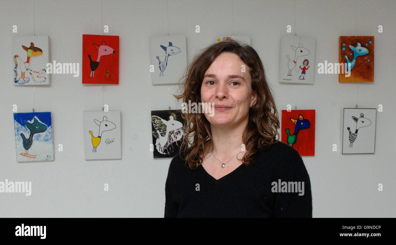 Artist Emma Harding in front of a series of pictures, which are all ...