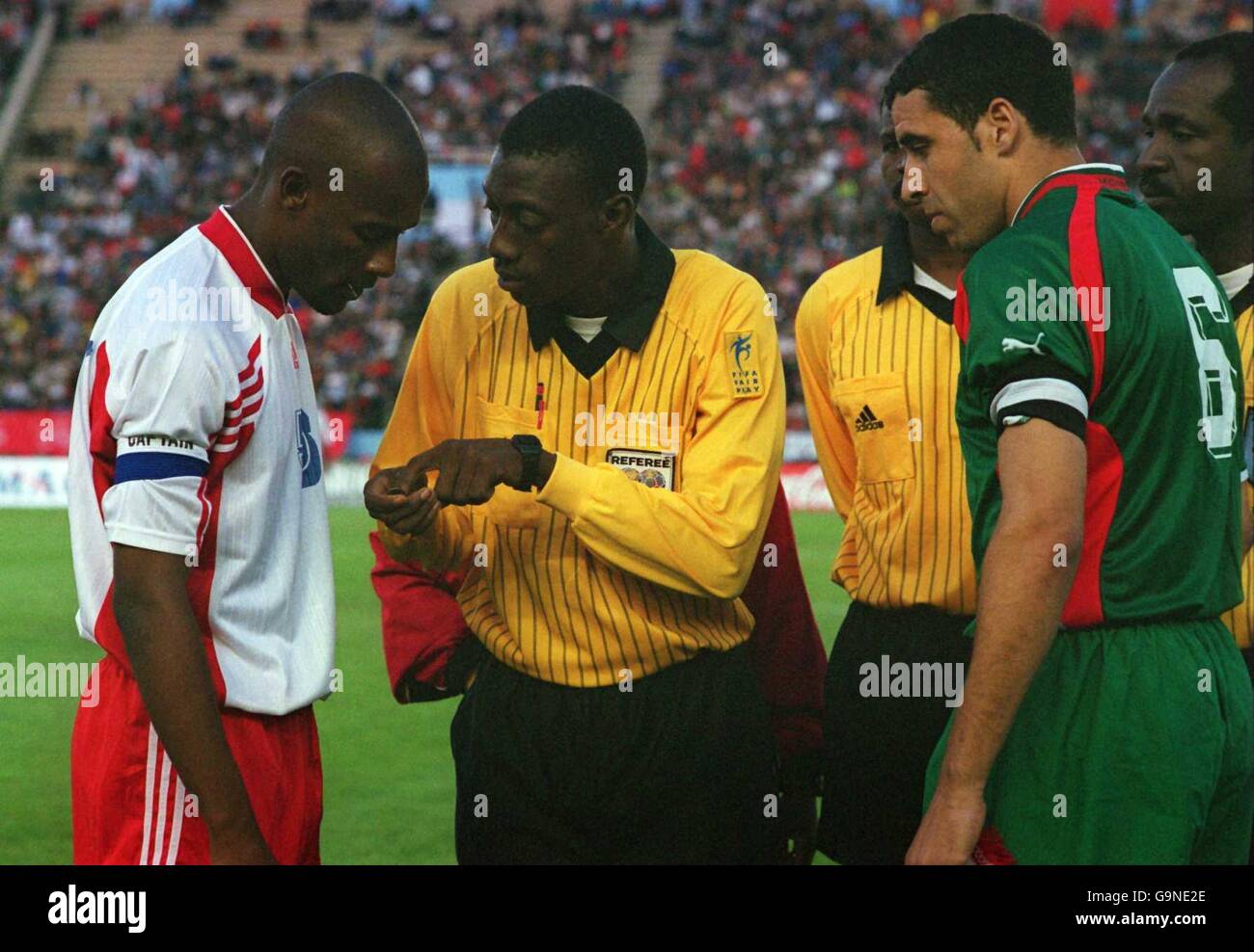 Referee Koman Coulibaly (c) asks Namibia's captain Mohammed Auseb (l ...