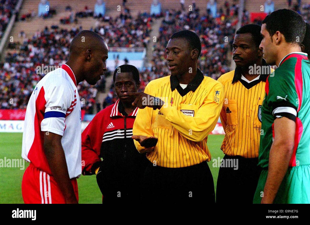 Referee Koman Coulibaly (c) asks Namibia's captain Mohammed Auseb (l ...