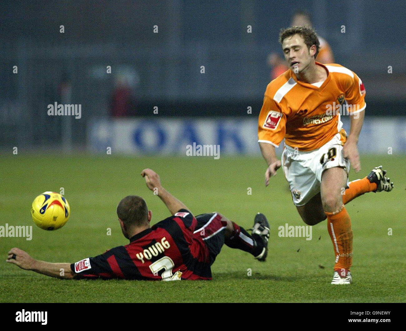 Blackpool's Andy Morrell (right) goes past Bournemouth's Neil Young ...