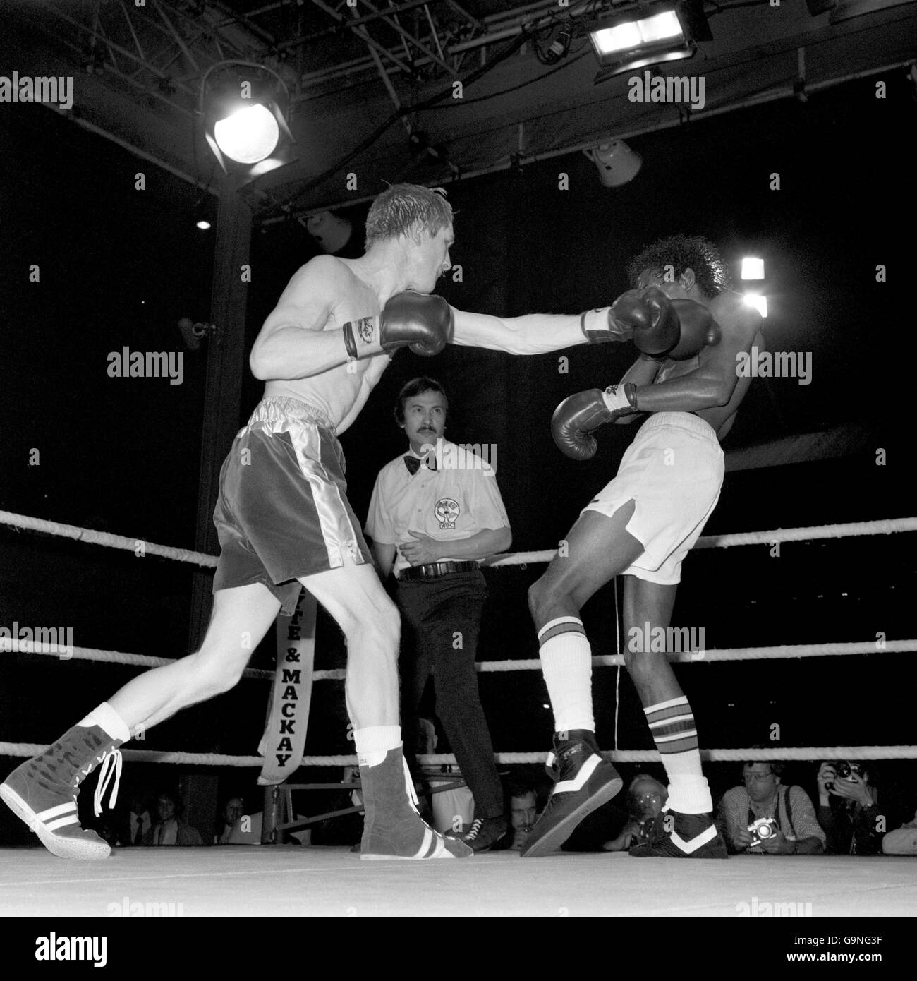 (L-R) World Lightweight Champion Jim Watt catches challenger Howard ...