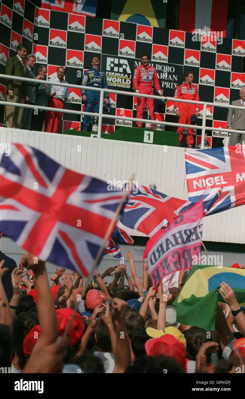 Nigel mansell on winners podium with union jack flags hi-res stock ...