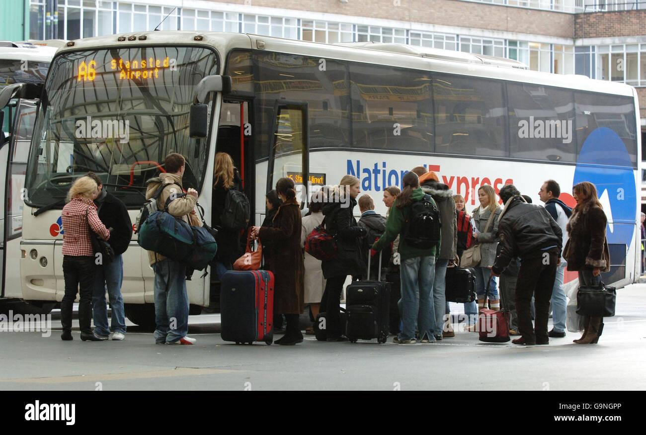 Passengers wait to board a National Express coach heading for Stanstead ...