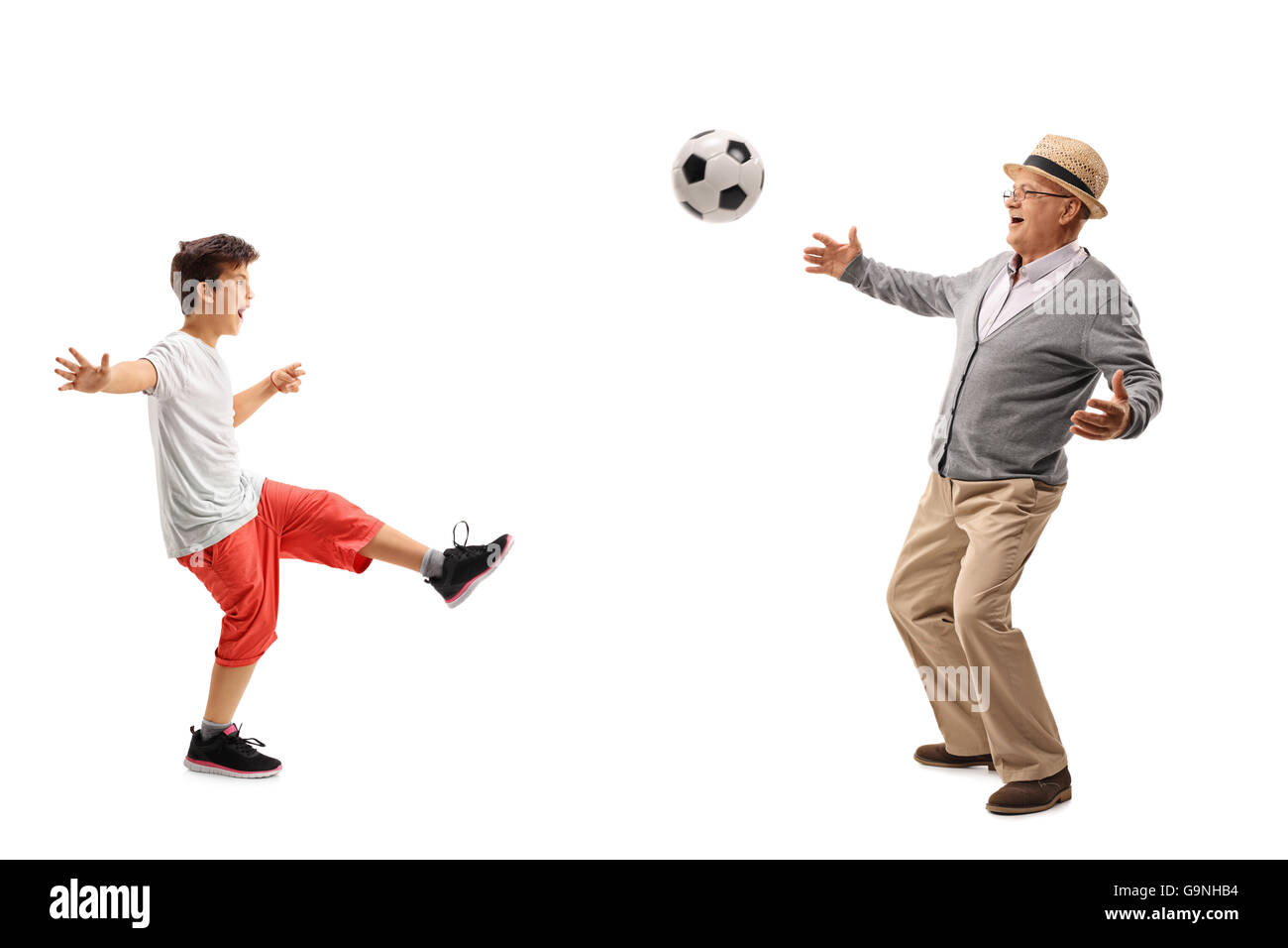 Senior man playing football with his grandson isolated on white ...